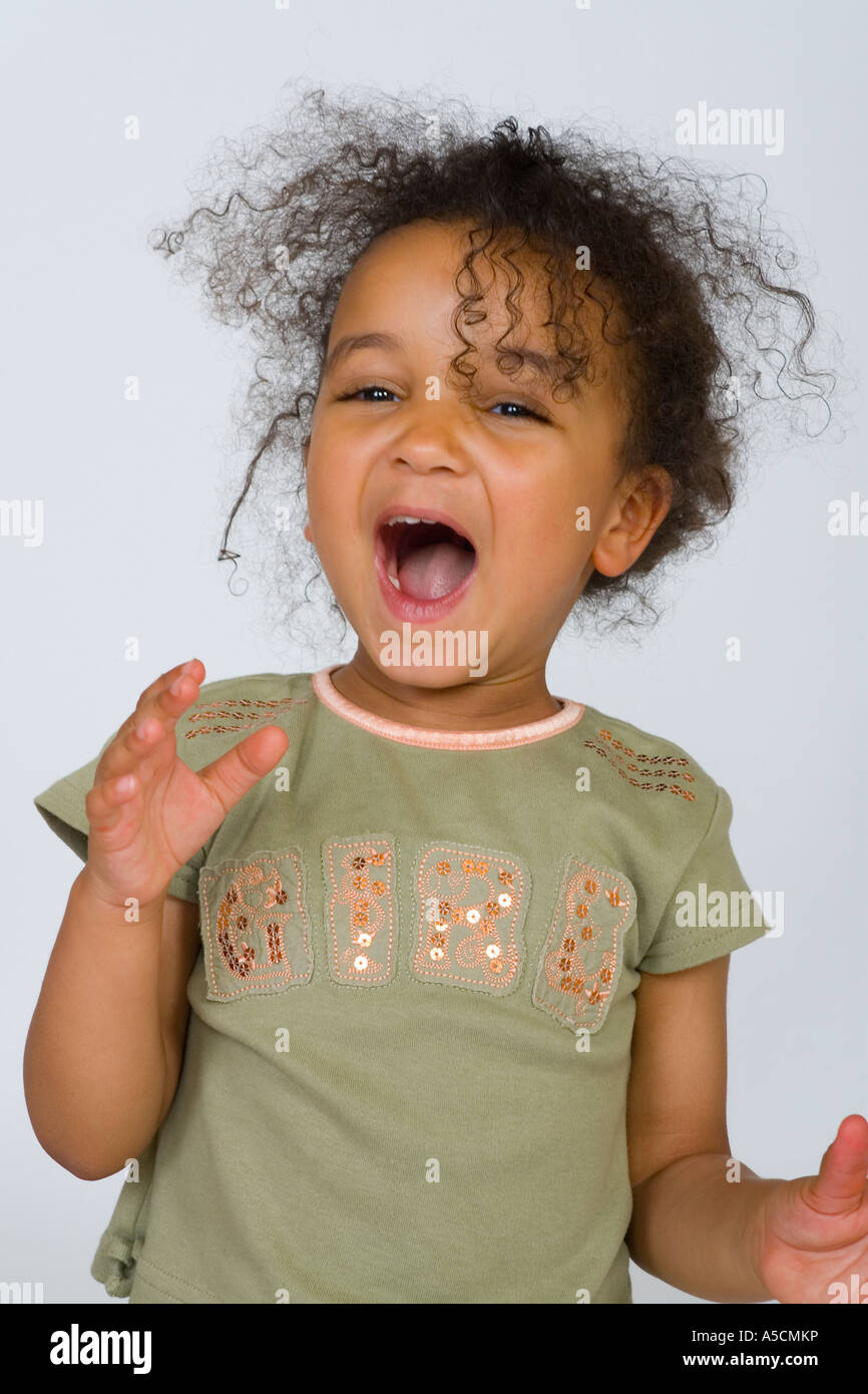 A beautiful mixed race girl singing out with joy Stock Photo - Alamy