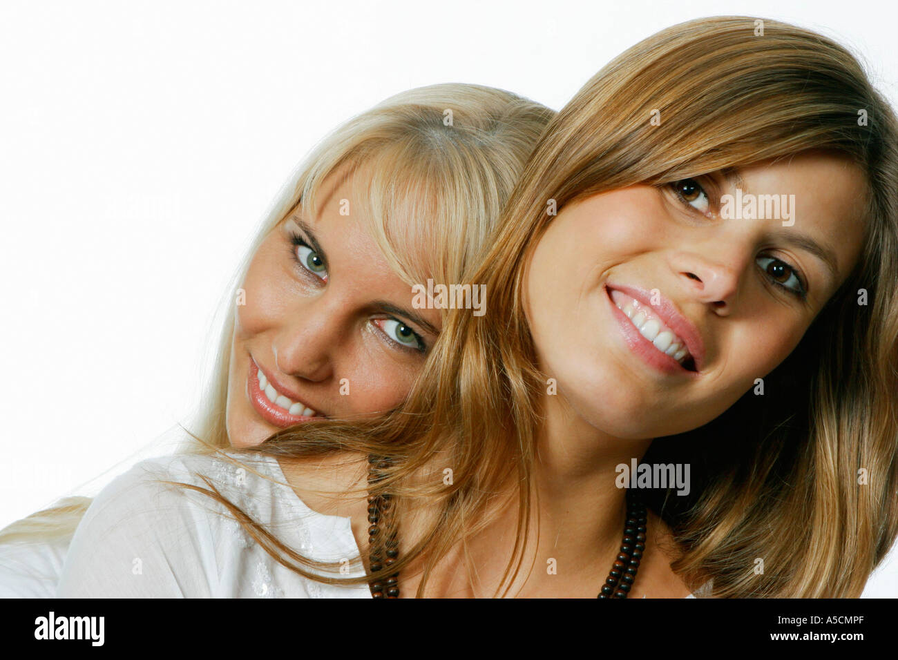 Woman leaning on each other's shoulder Stock Photo - Alamy
