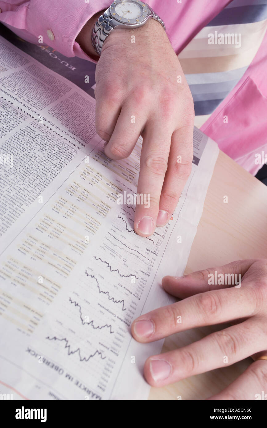Businessman reading a business paper Stock Photo - Alamy