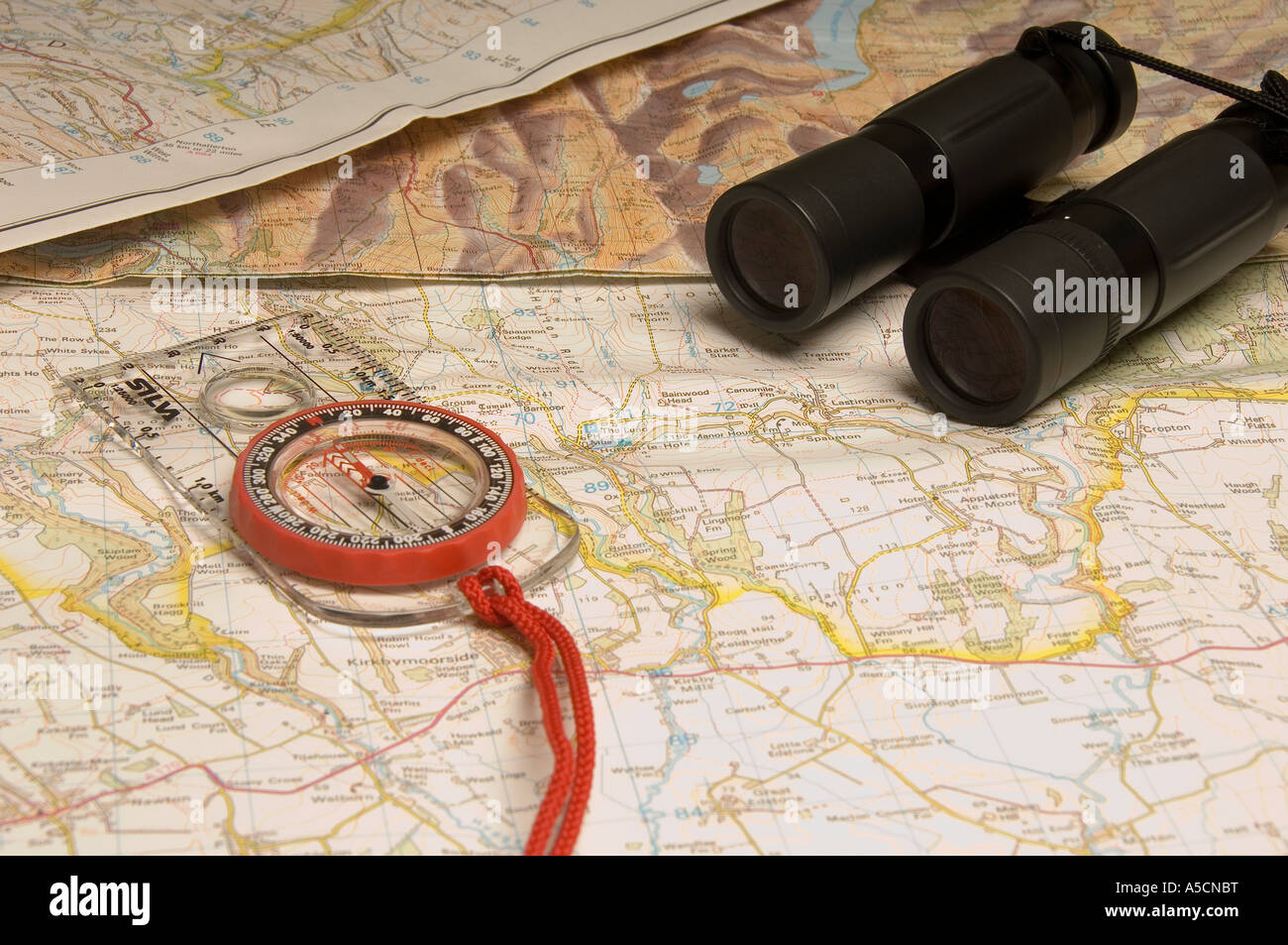 Close up of maps Map compass and binoculars Stock Photo - Alamy