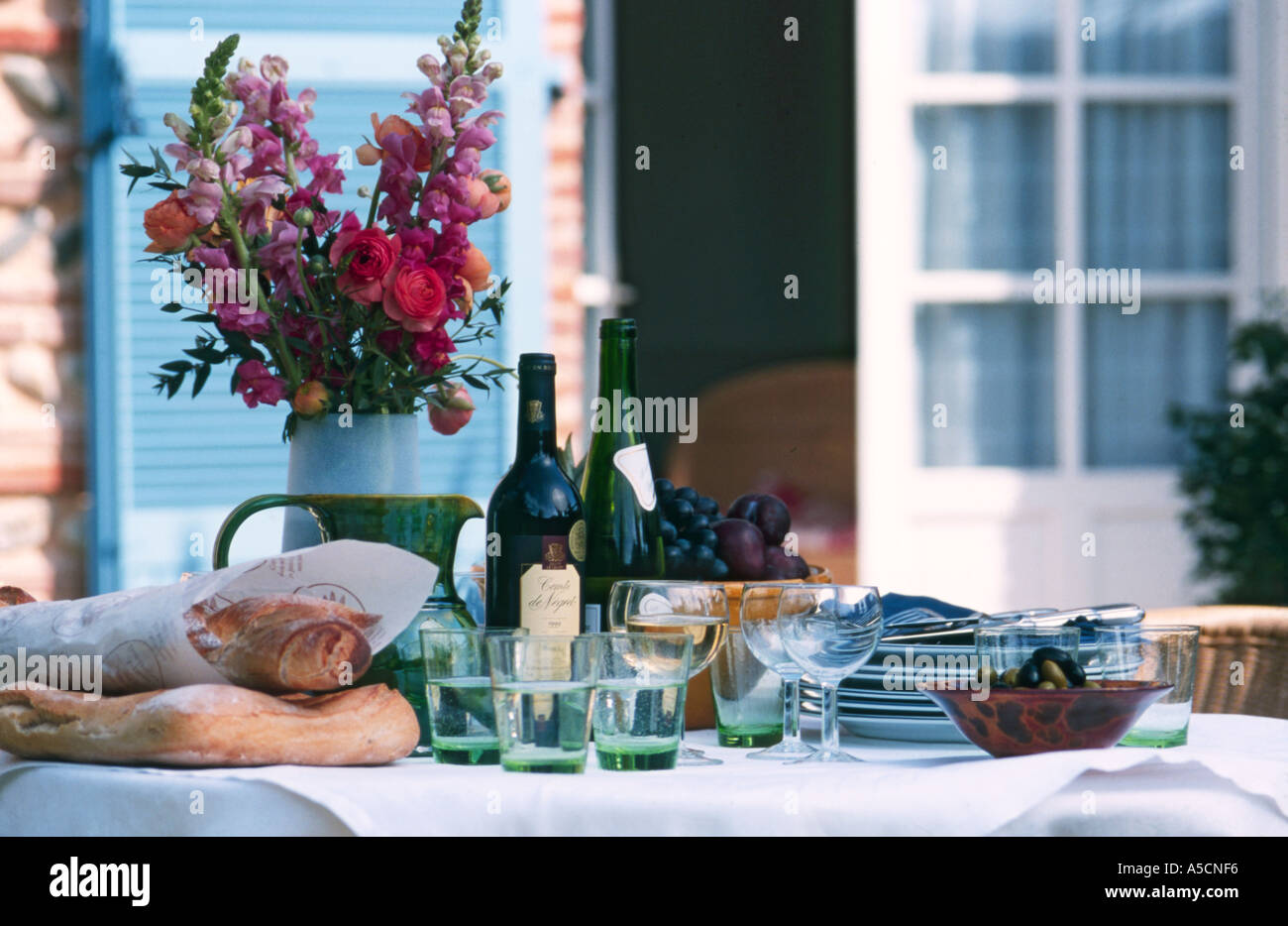 Table set outside for light summer lunch Stock Photo - Alamy
