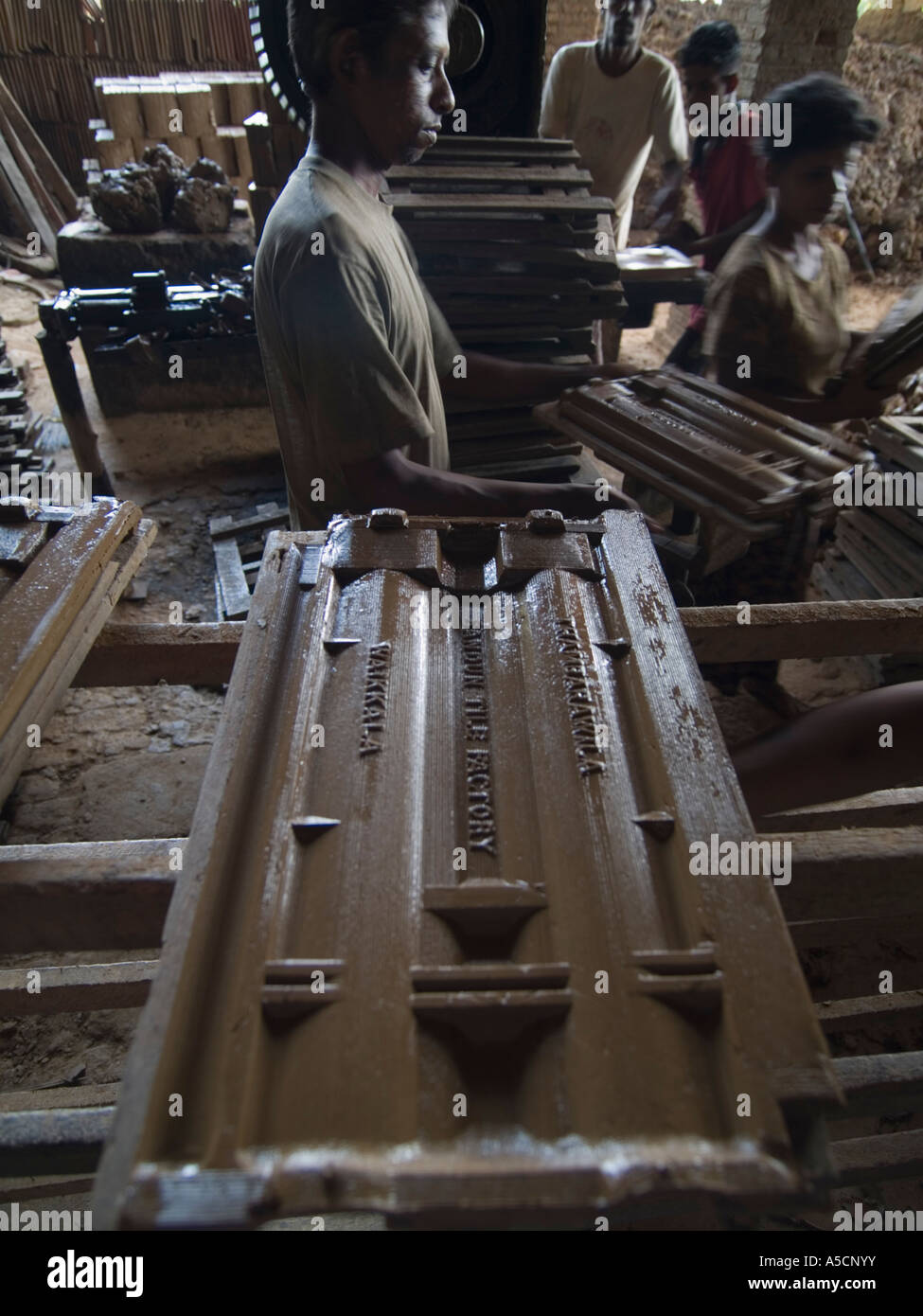Laborers at work in a ceramic roofing tile factory Stock Photo - Alamy