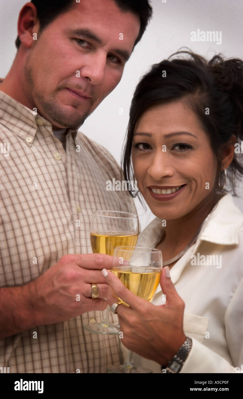 Hispanic couple making a champagne toast Stock Photo - Alamy