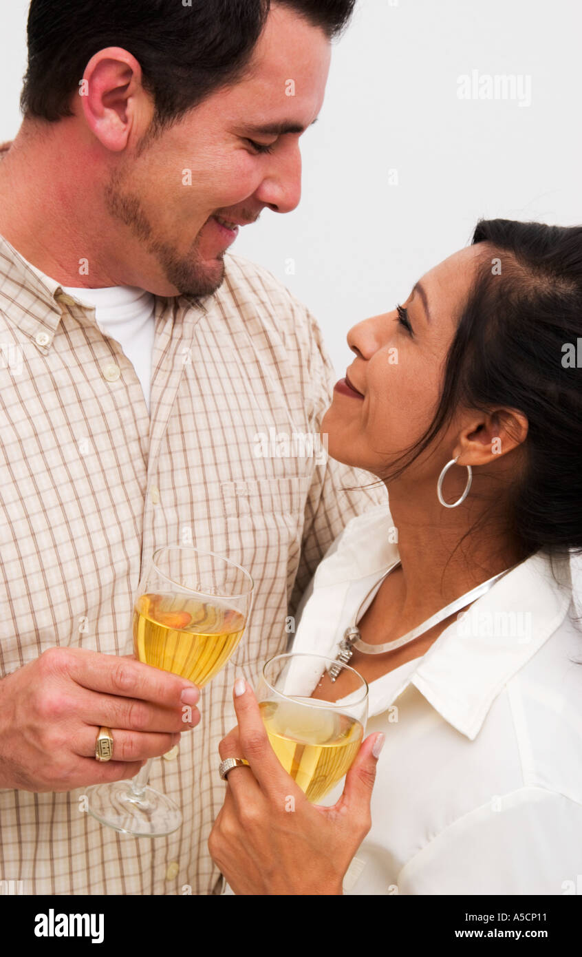Hispanic couple making a champagne toast Stock Photo - Alamy