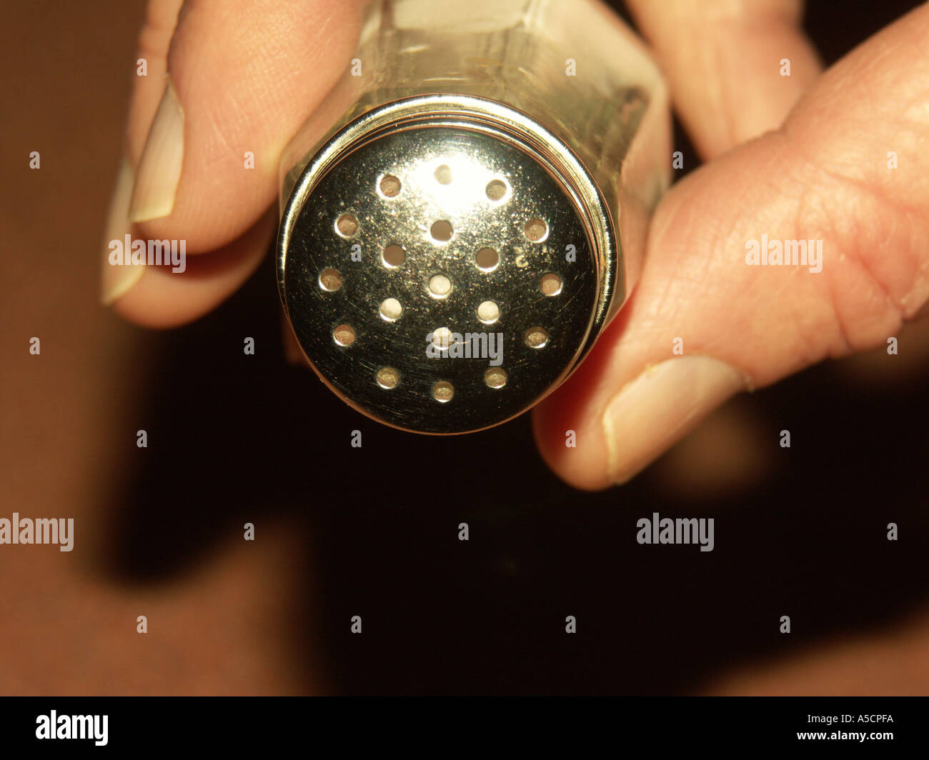 Hand with salt shaker Stock Photo - Alamy