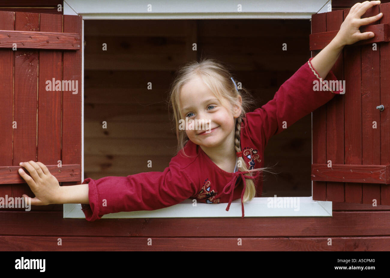 Child leaning out open window hi-res stock photography and images - Alamy