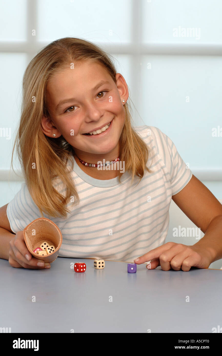 Girl playing with dice, portrait Stock Photo - Alamy