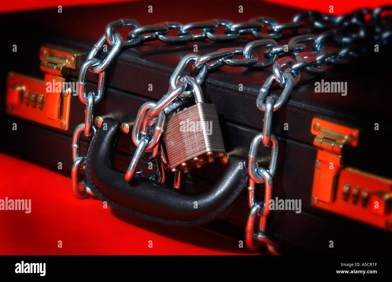 Briefcase in chains Stock Photo - Alamy