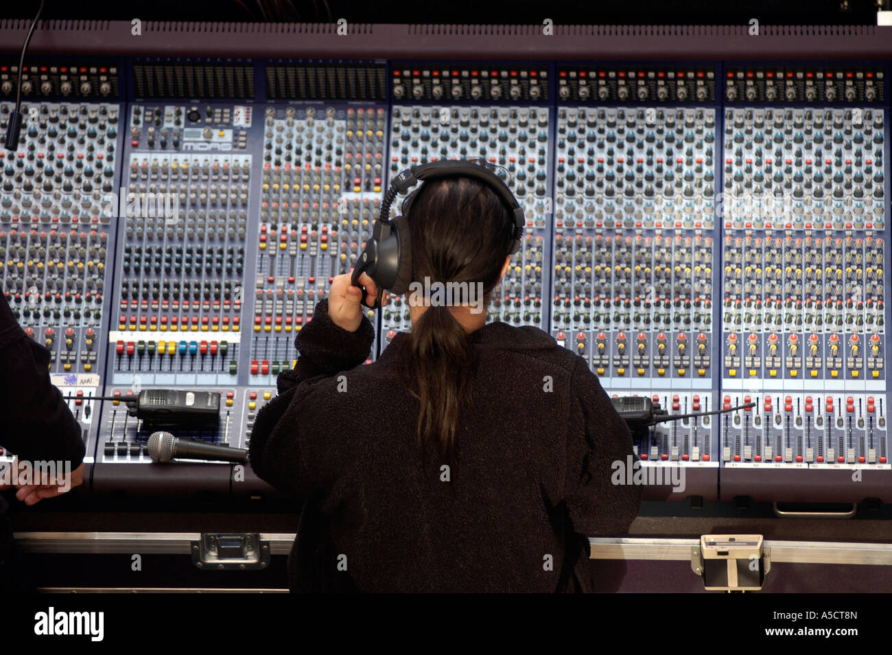 A sound technician adjusts a sound board during a performance Stock ...
