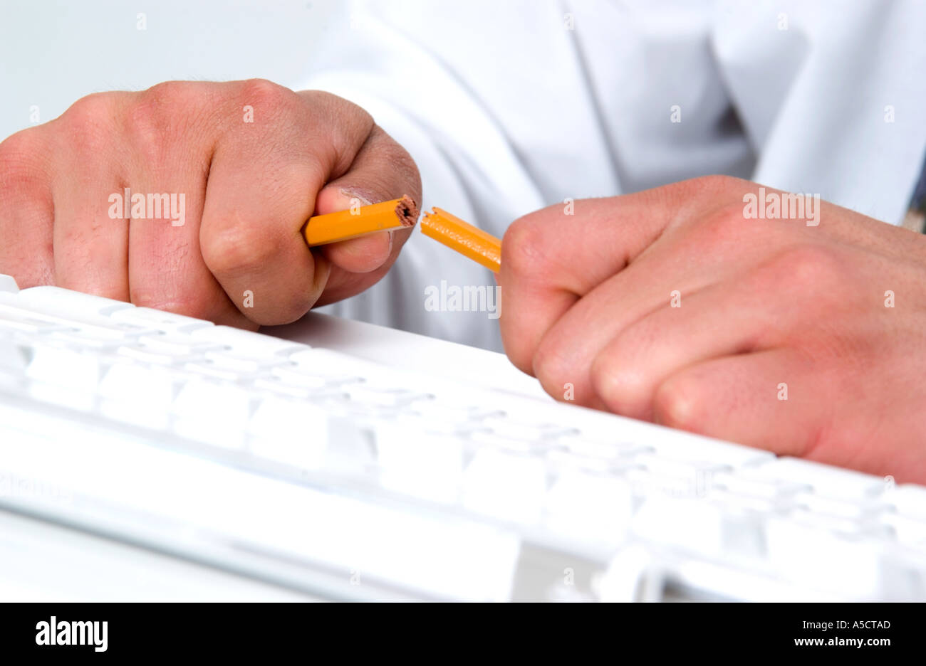 Man at computer breaking a pencil Stock Photo - Alamy