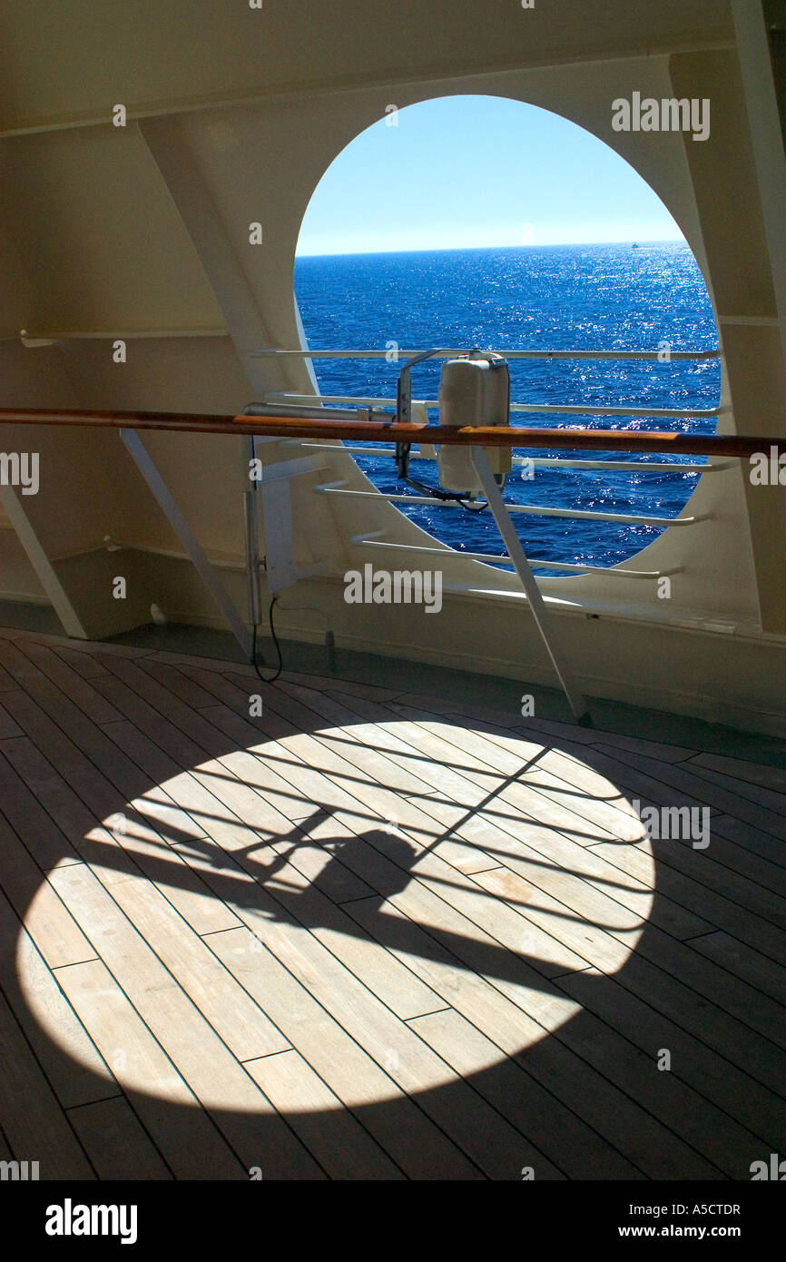Close up of cruise ship deck showing large porthole with view of ocean ...