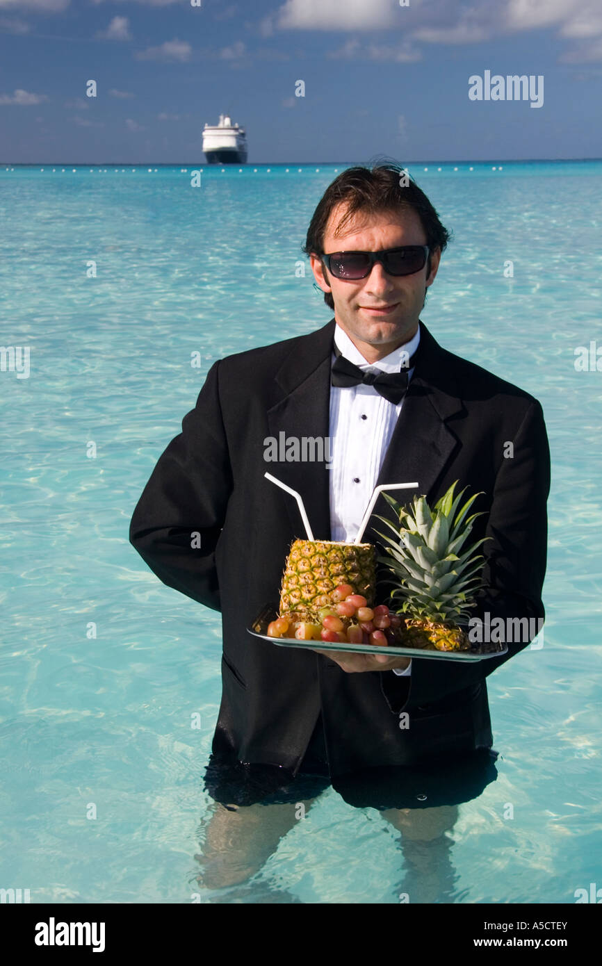 Waiter standing in water at beach at Half Moon Cay Bahamas Stock Photo ...