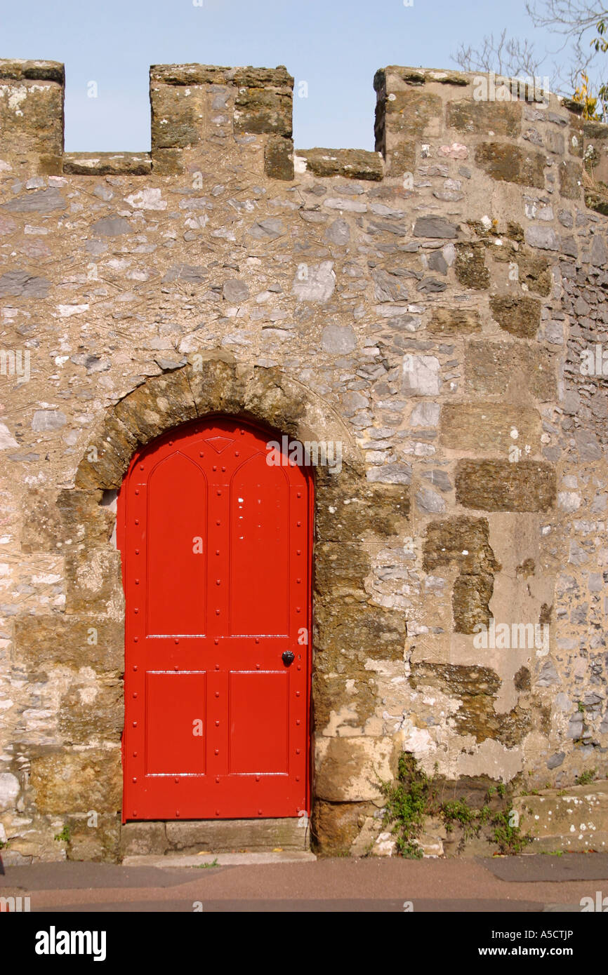 Painted wooden red door set in to the castellated walls. Arundel Castle ...