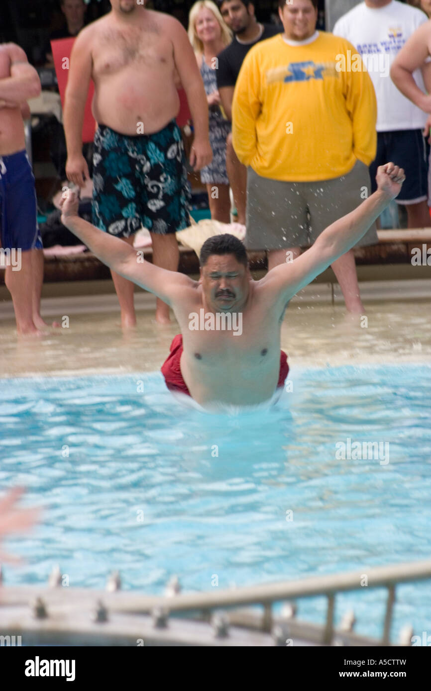 Man doing belly flop in a cruise ship swimming pool in a belly flop ...