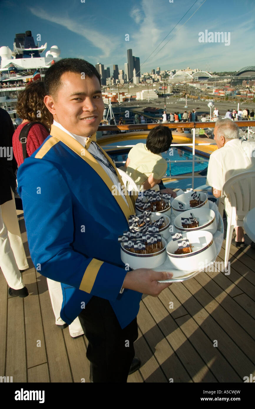 Cruise ship waiter serving drinks aboard the Holland America Line ...
