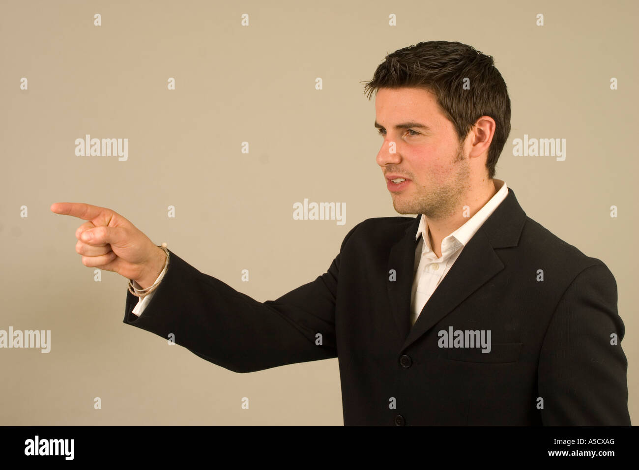Young man points in an accusing manner Stock Photo - Alamy