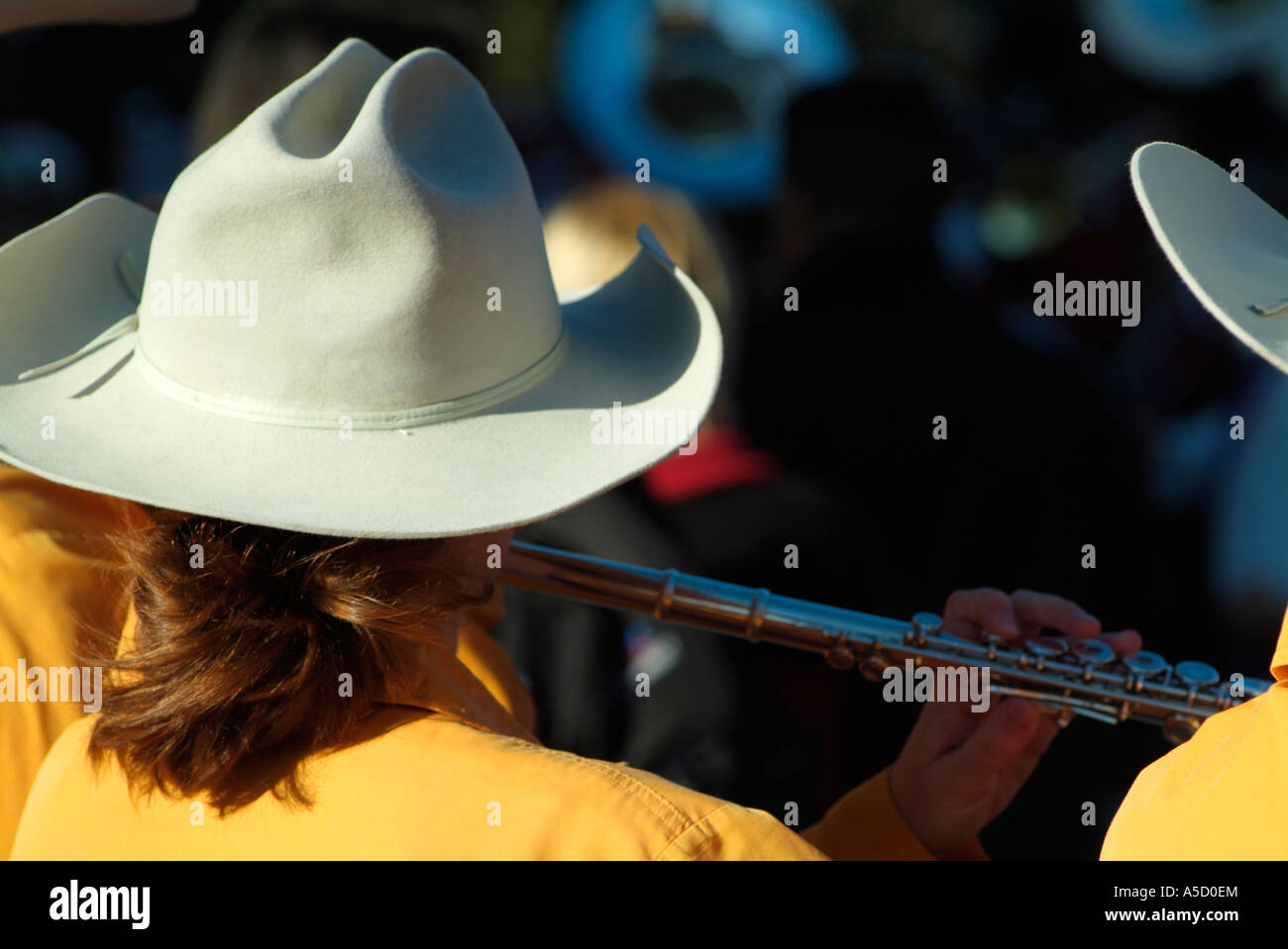 Young woman wearing a cow boy costume and playing flute Stock Photo - Alamy