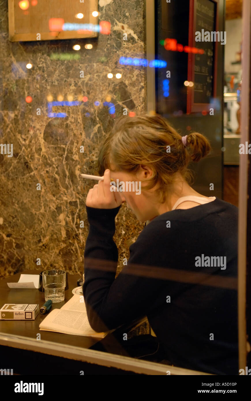 Young woman smoking in a bar in Paris at night Stock Photo - Alamy