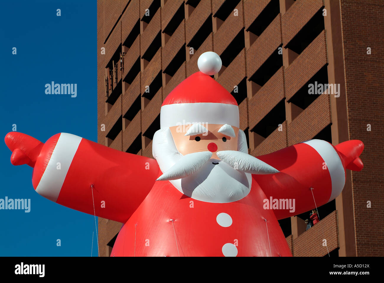 Inflatable santa claus floating in a street Stock Photo - Alamy