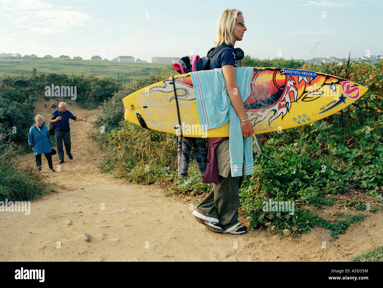 Blonde female surfer with surfboard, Fistral Beach, Newquay, Cornwall ...