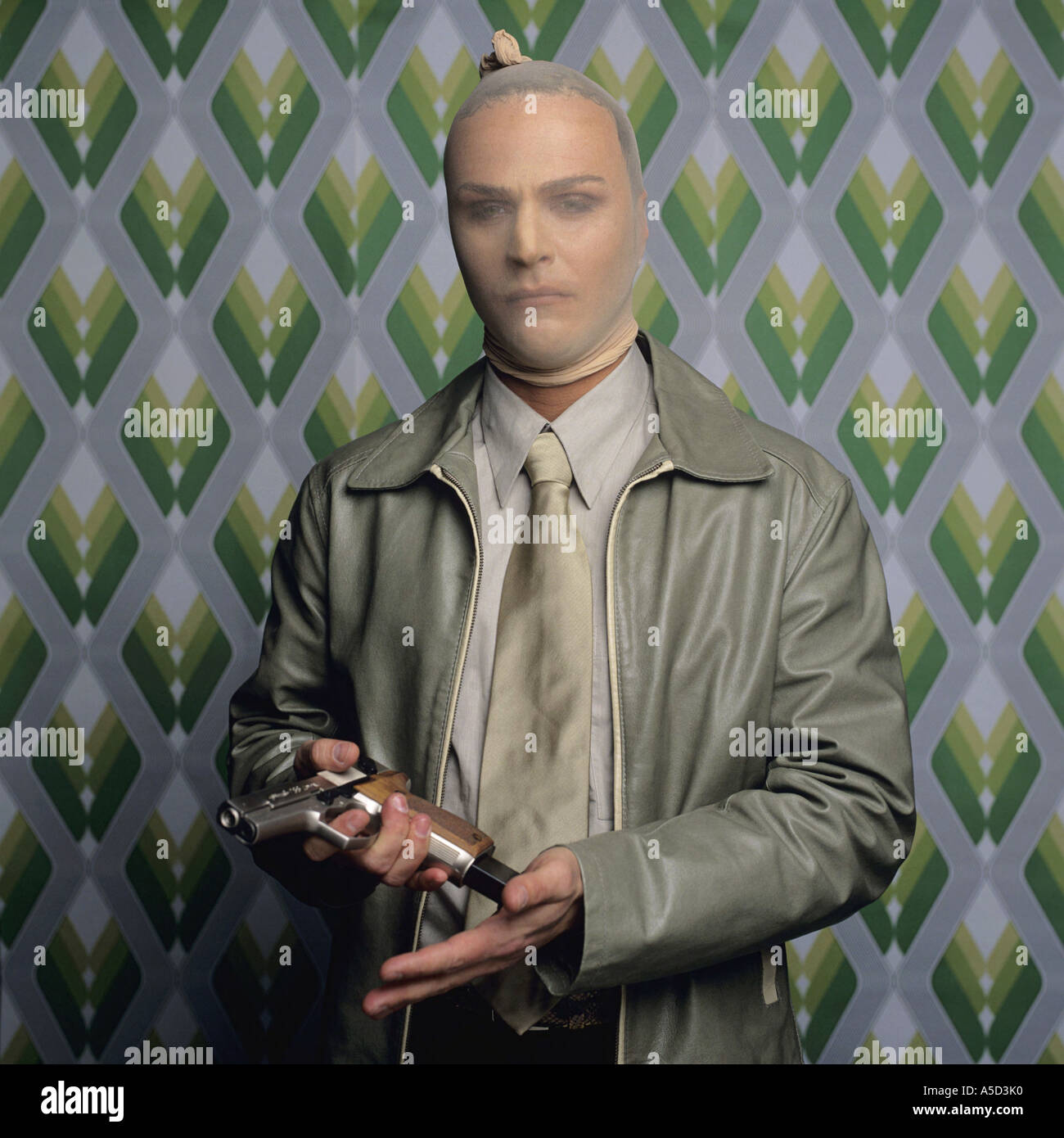 Robber in disguise holding gun, portrait Stock Photo - Alamy