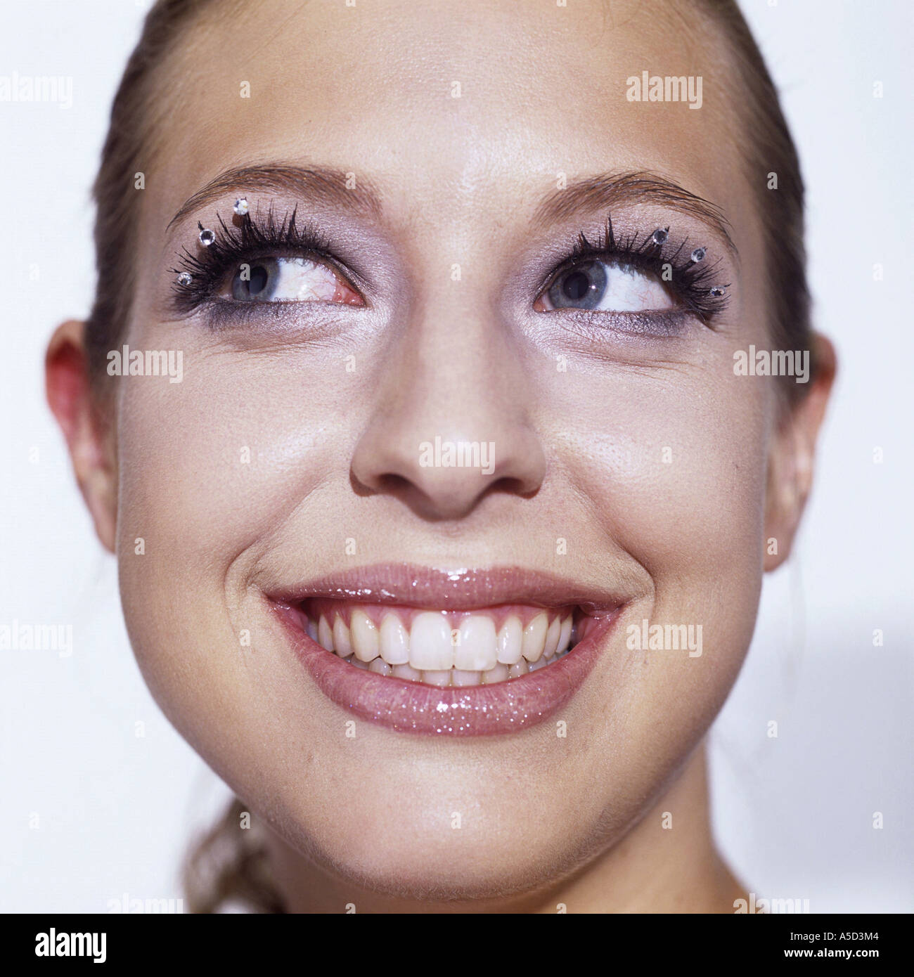 Young woman smiling, looking up Stock Photo - Alamy