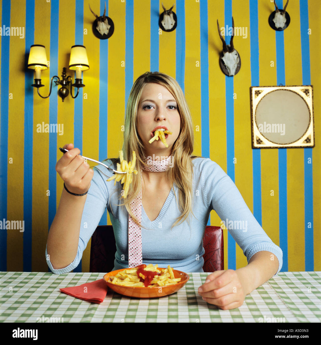 Young woman eating french fries Stock Photo - Alamy