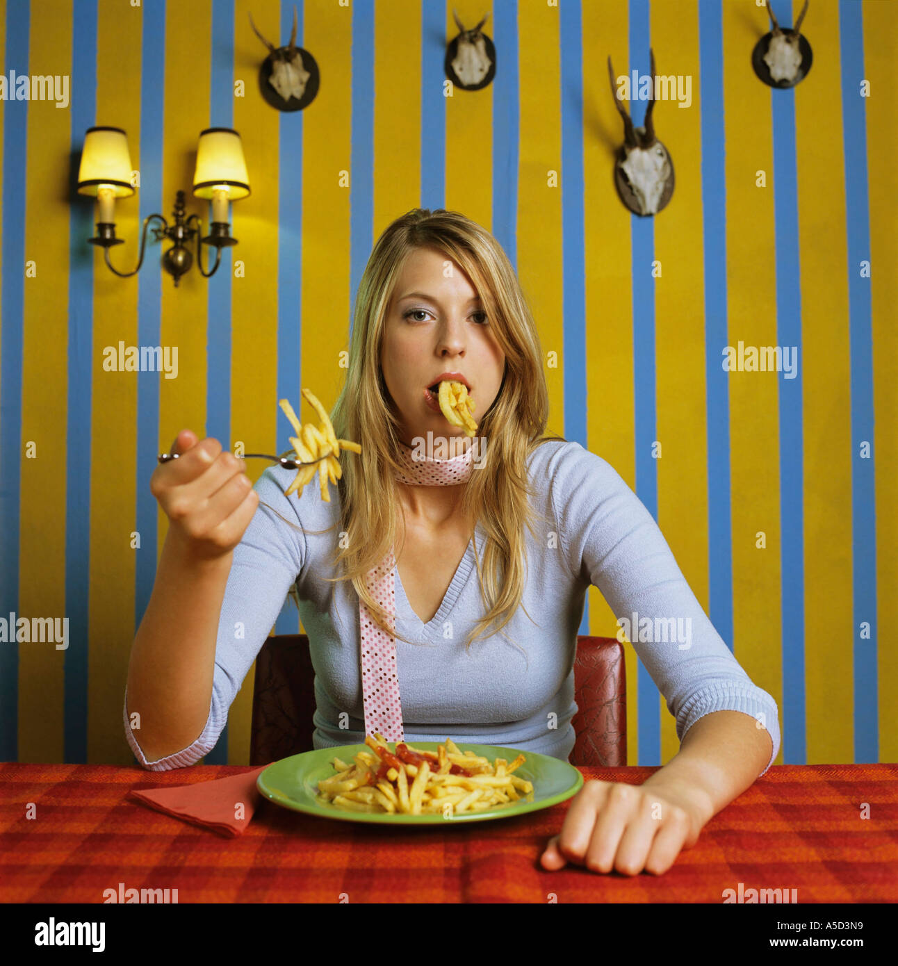 Woman french fries looking at camera hi-res stock photography and ...