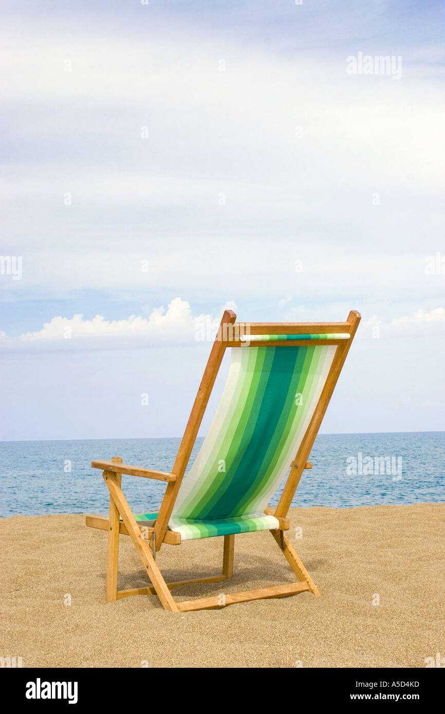 Beach chair on sand at beach, rear view Stock Photo - Alamy