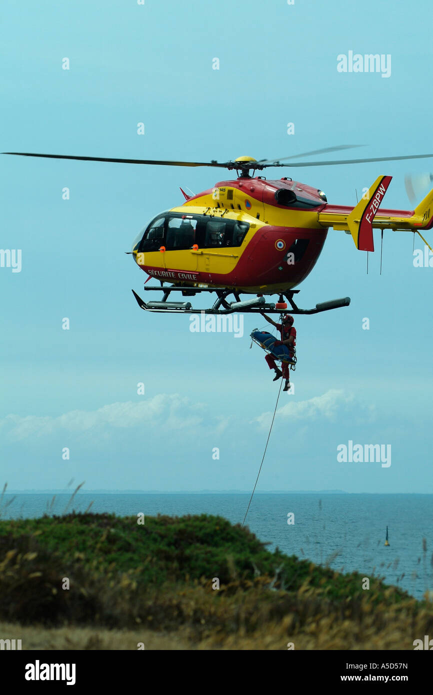 Helicopter rescuing people fallen from a cliff in Brittany Stock Photo ...