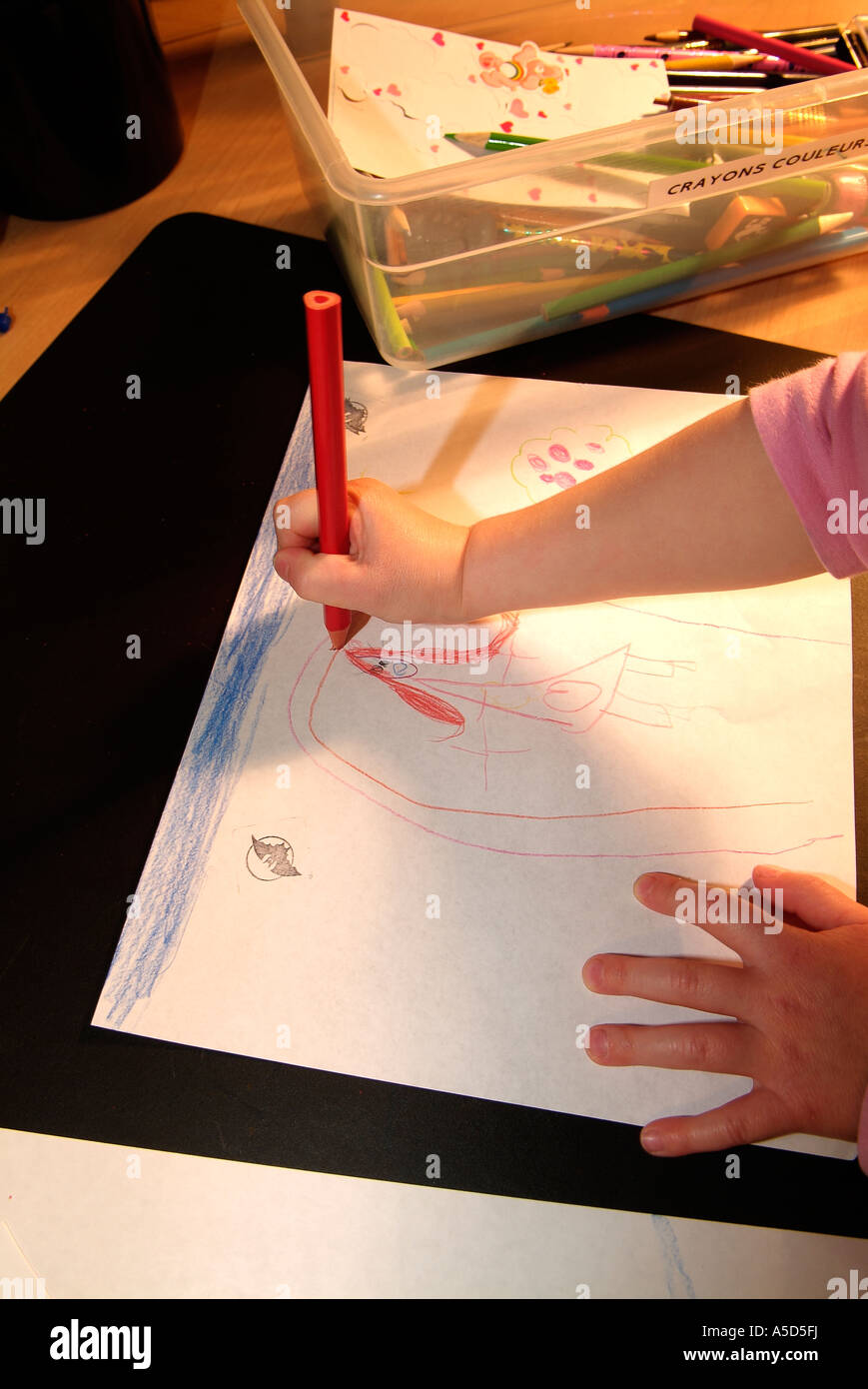 Young girl drawing on paper Stock Photo - Alamy