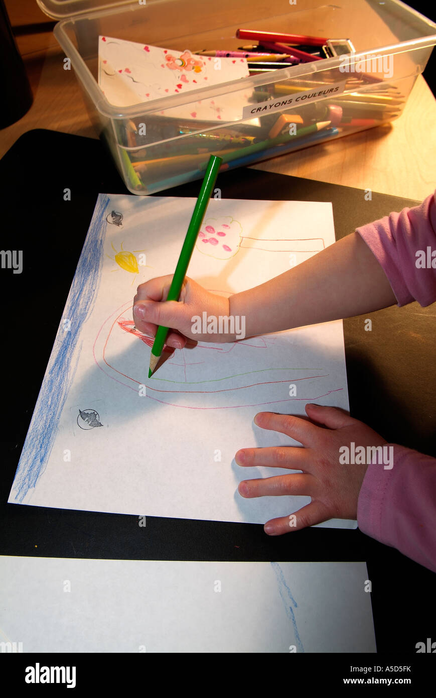 Young girl drawing on paper Stock Photo - Alamy