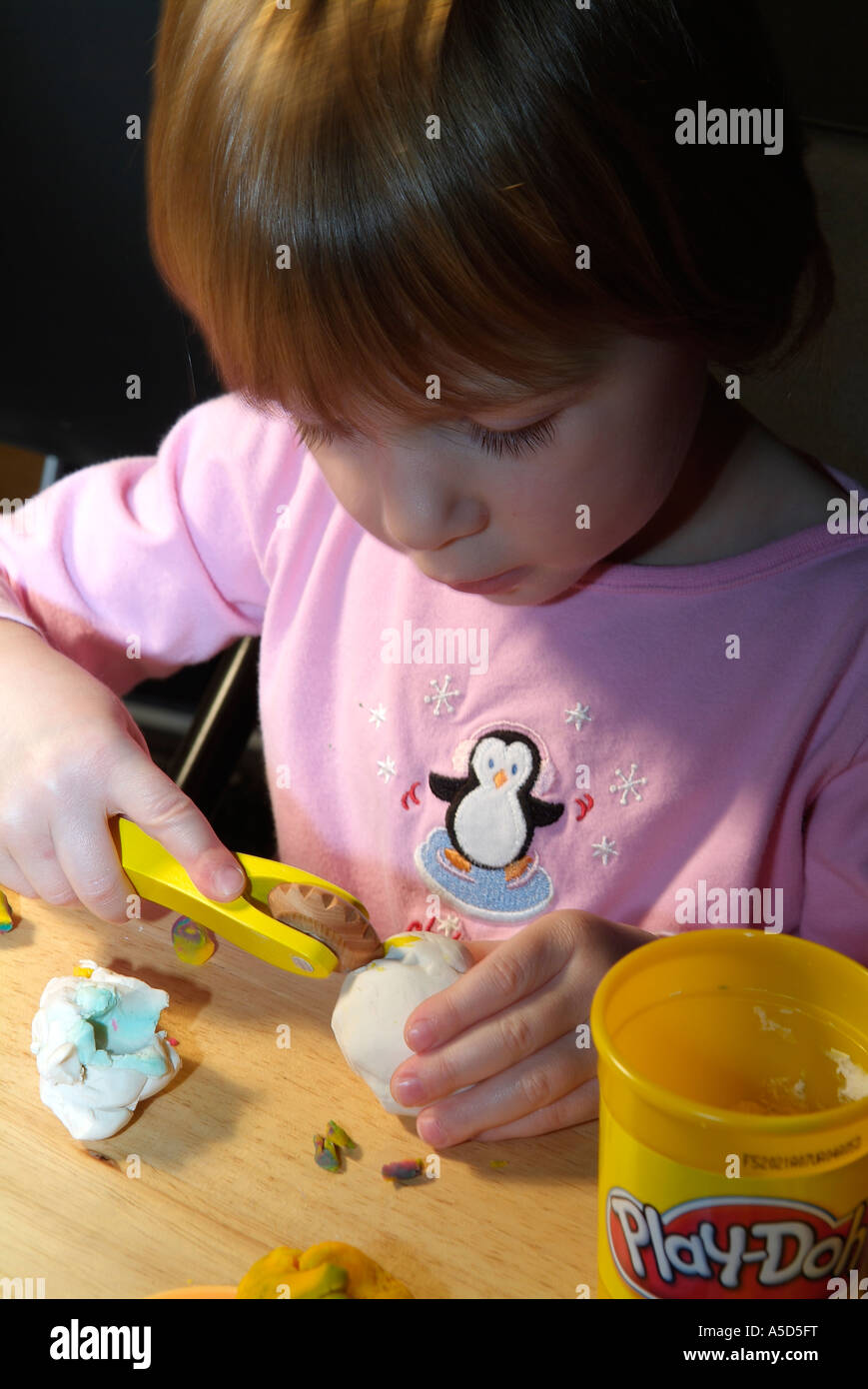 Young girl playing with modeling clay hi-res stock photography and ...