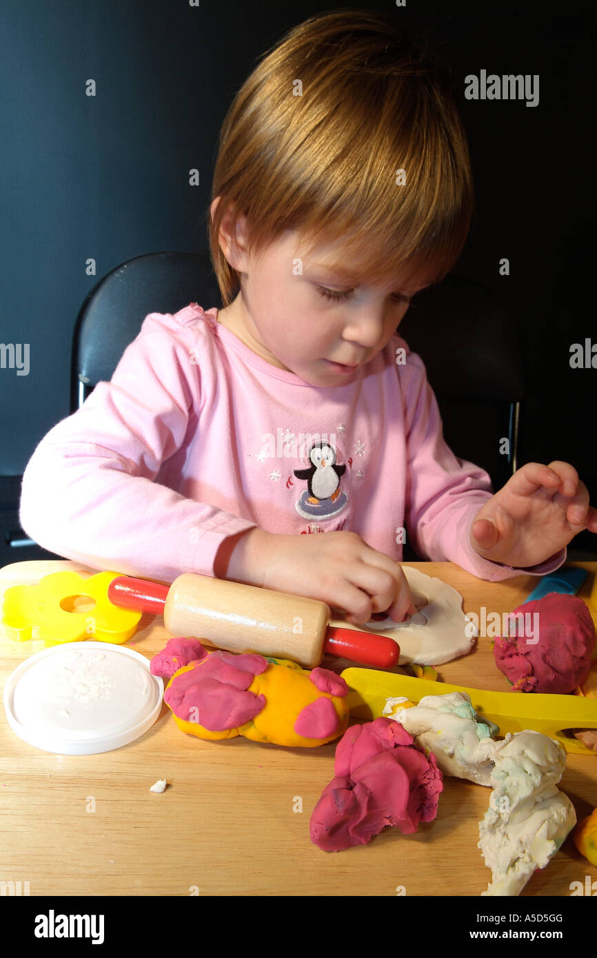 Young girl playing with modeling clay Stock Photo - Alamy
