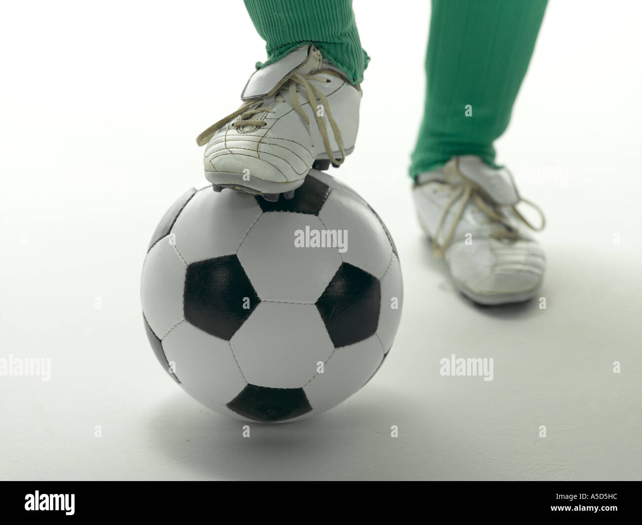 Soccer player's feet on a football Stock Photo - Alamy