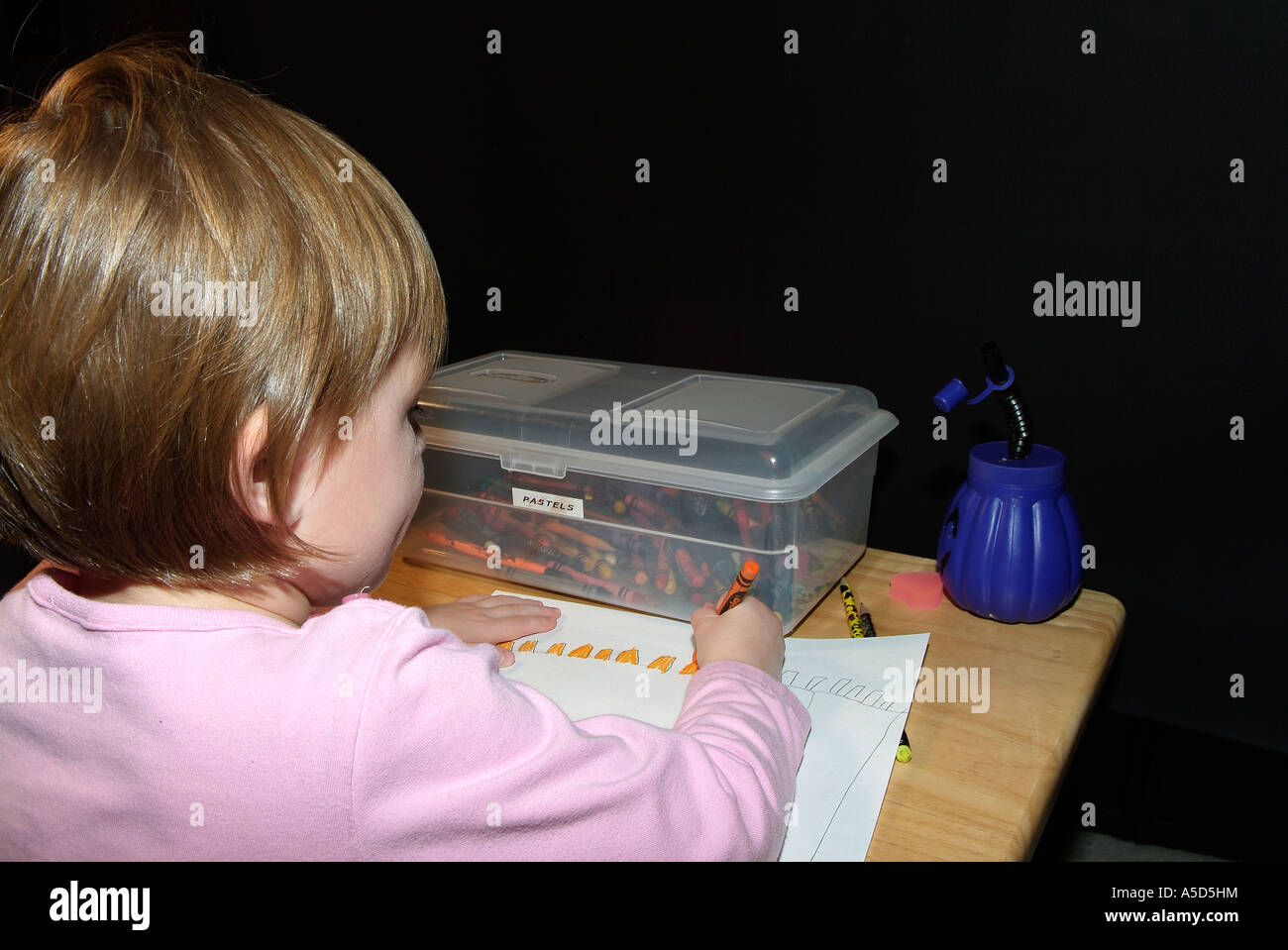 Young girl drawing on paper Stock Photo - Alamy