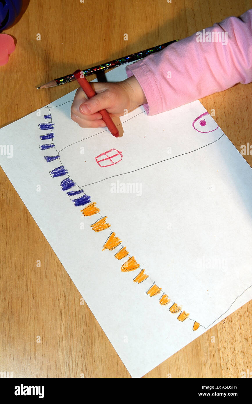 Young girl drawing on paper Stock Photo - Alamy