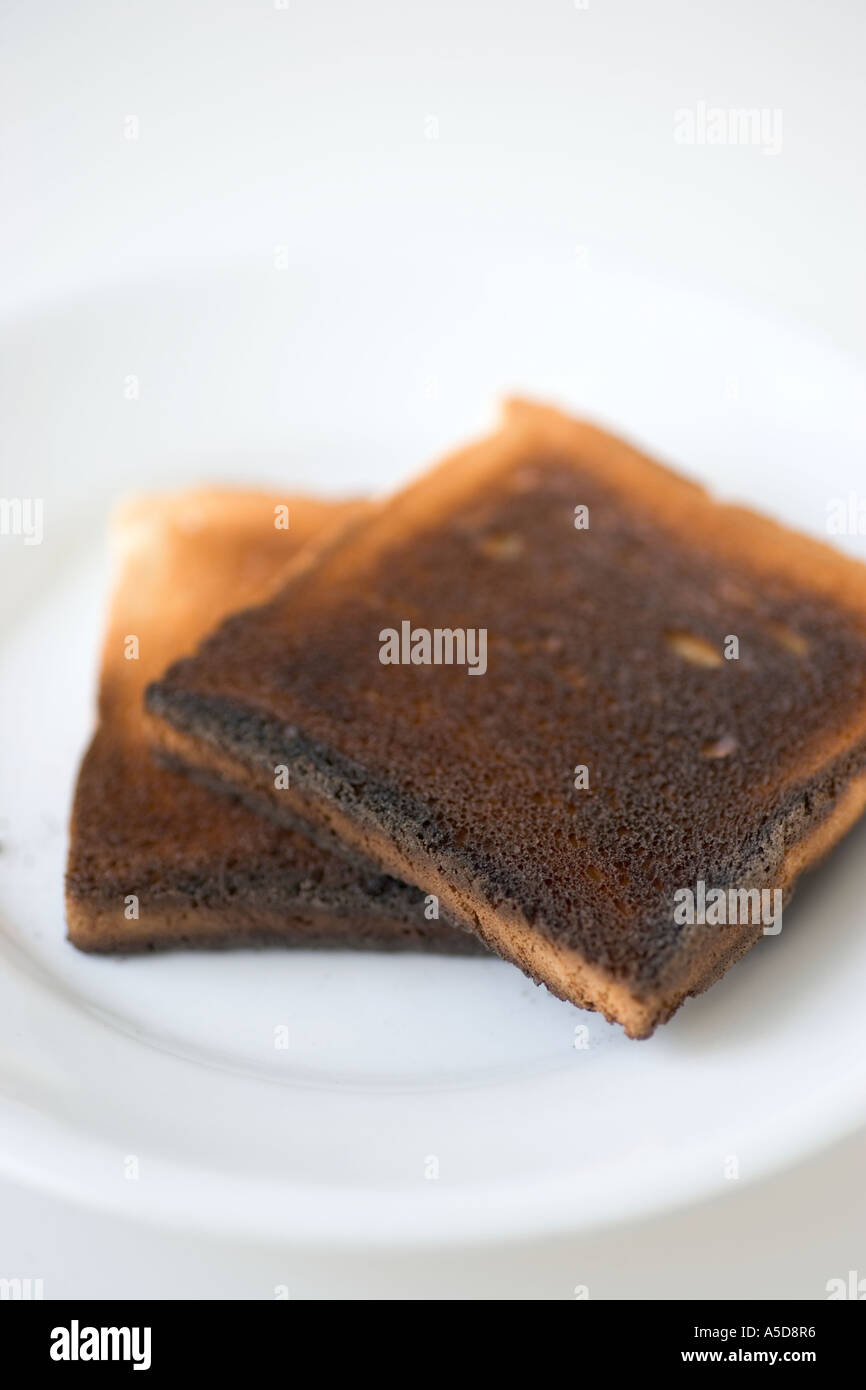 Two slices of burned toast, close-up Stock Photo - Alamy
