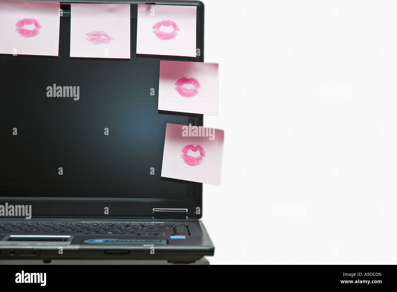Lipstick kisses on adhesive notes on laptop computer Stock Photo - Alamy