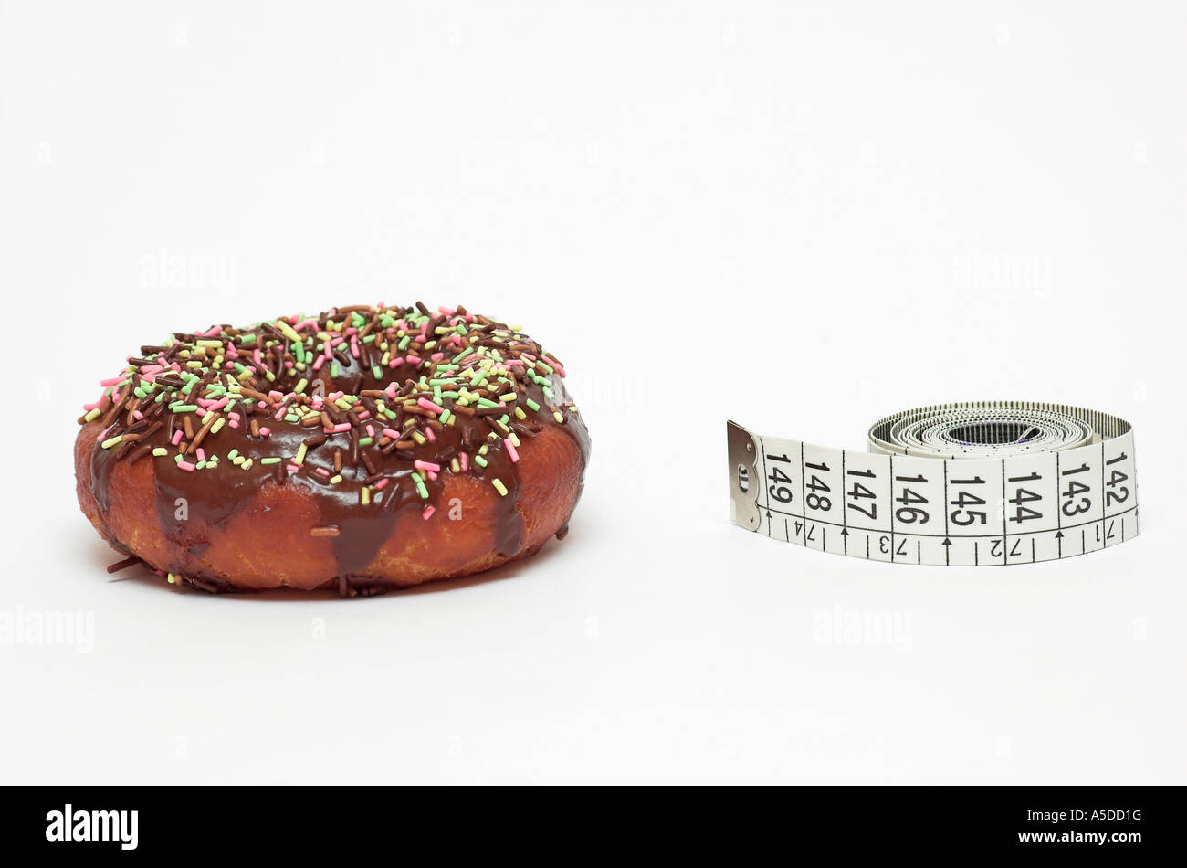 Tape measure and doughnut close up Stock Photo - Alamy