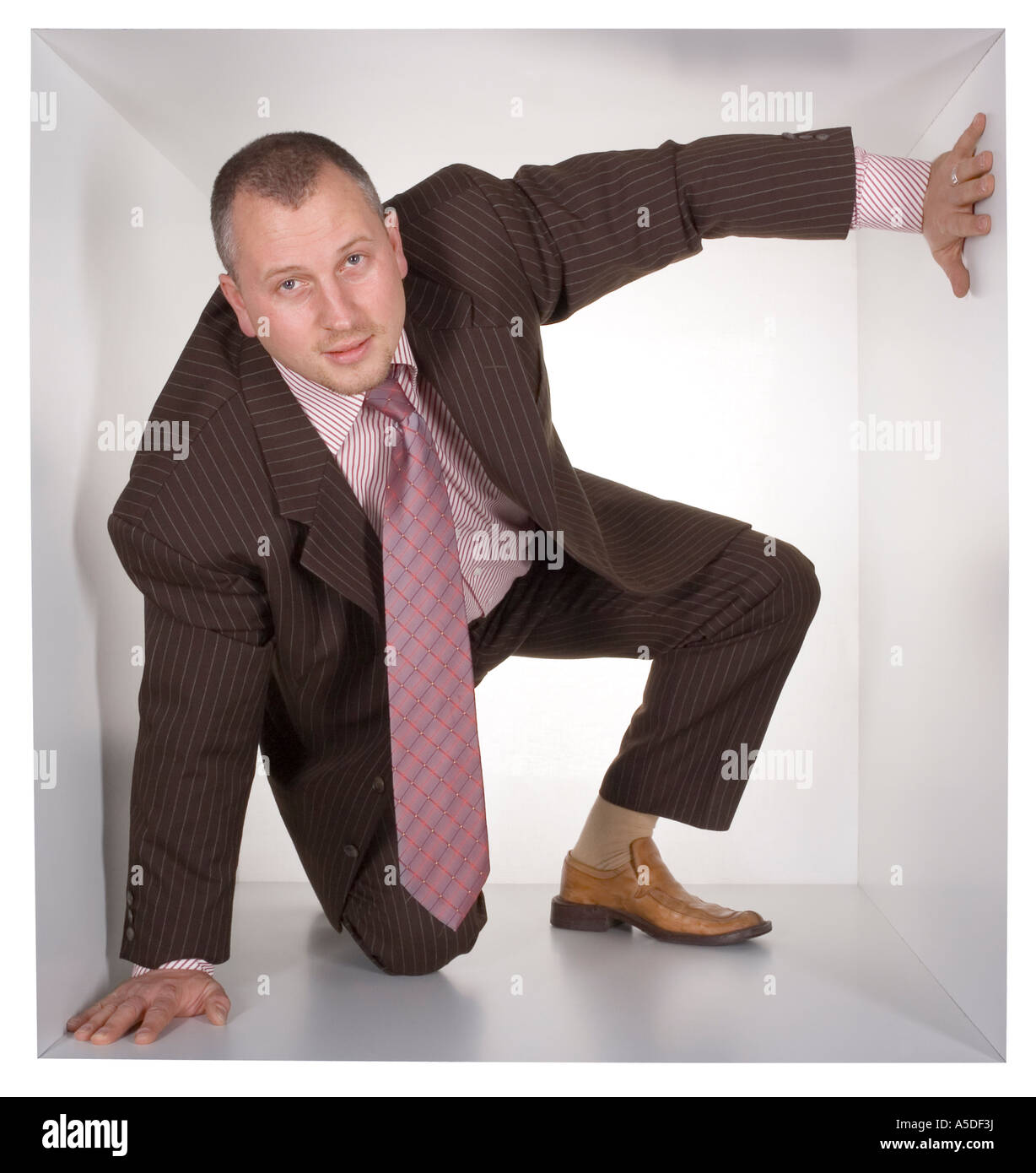 businessman in the cramped white cube Stock Photo - Alamy