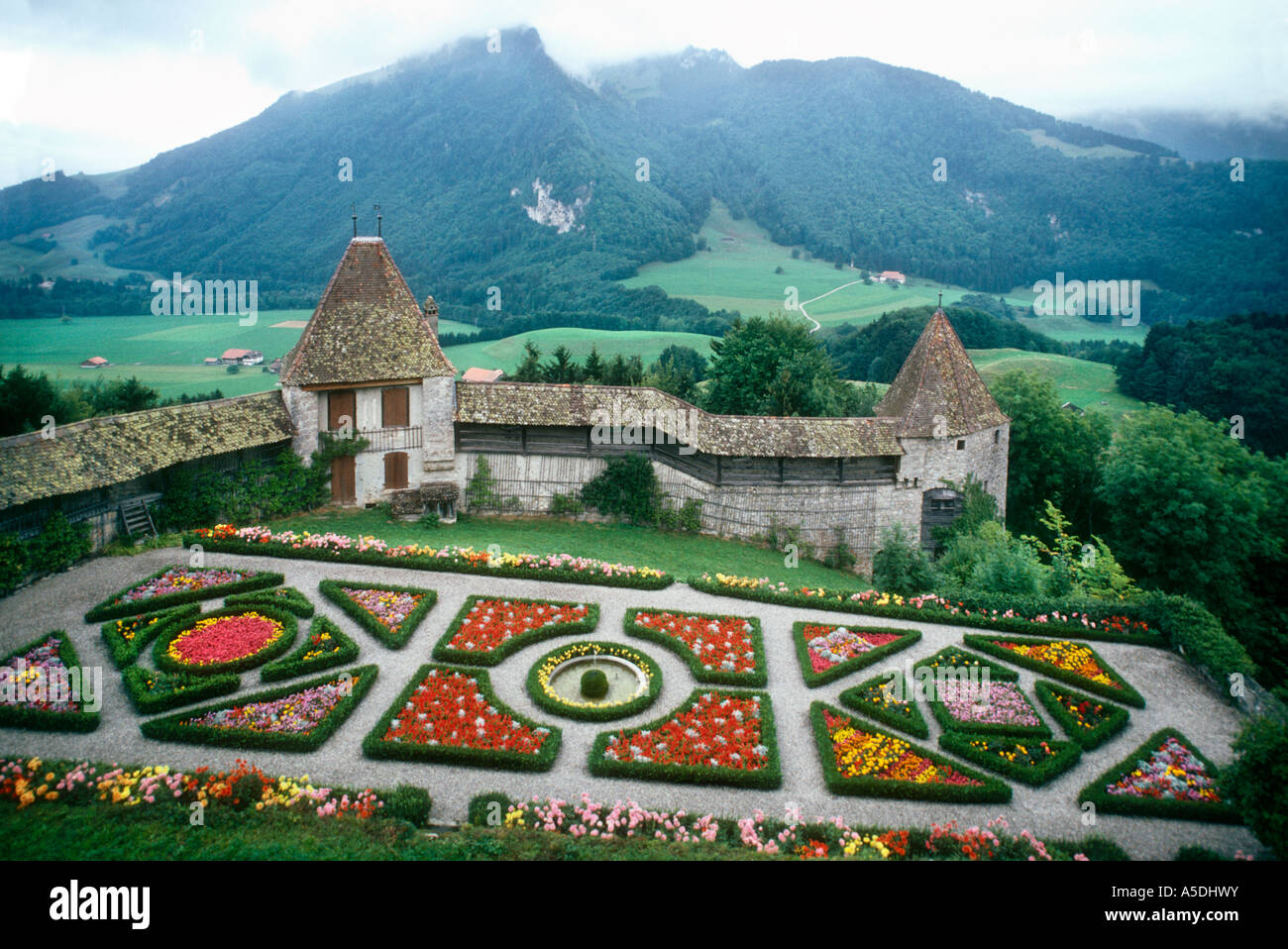 View of the old ramparts of Gruyere castle surrounding the colourful ...