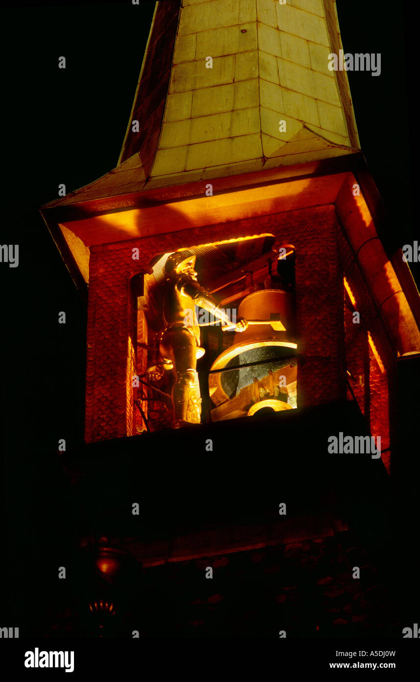 Close up illuminated night view of a huge bell tower, inside a little ...