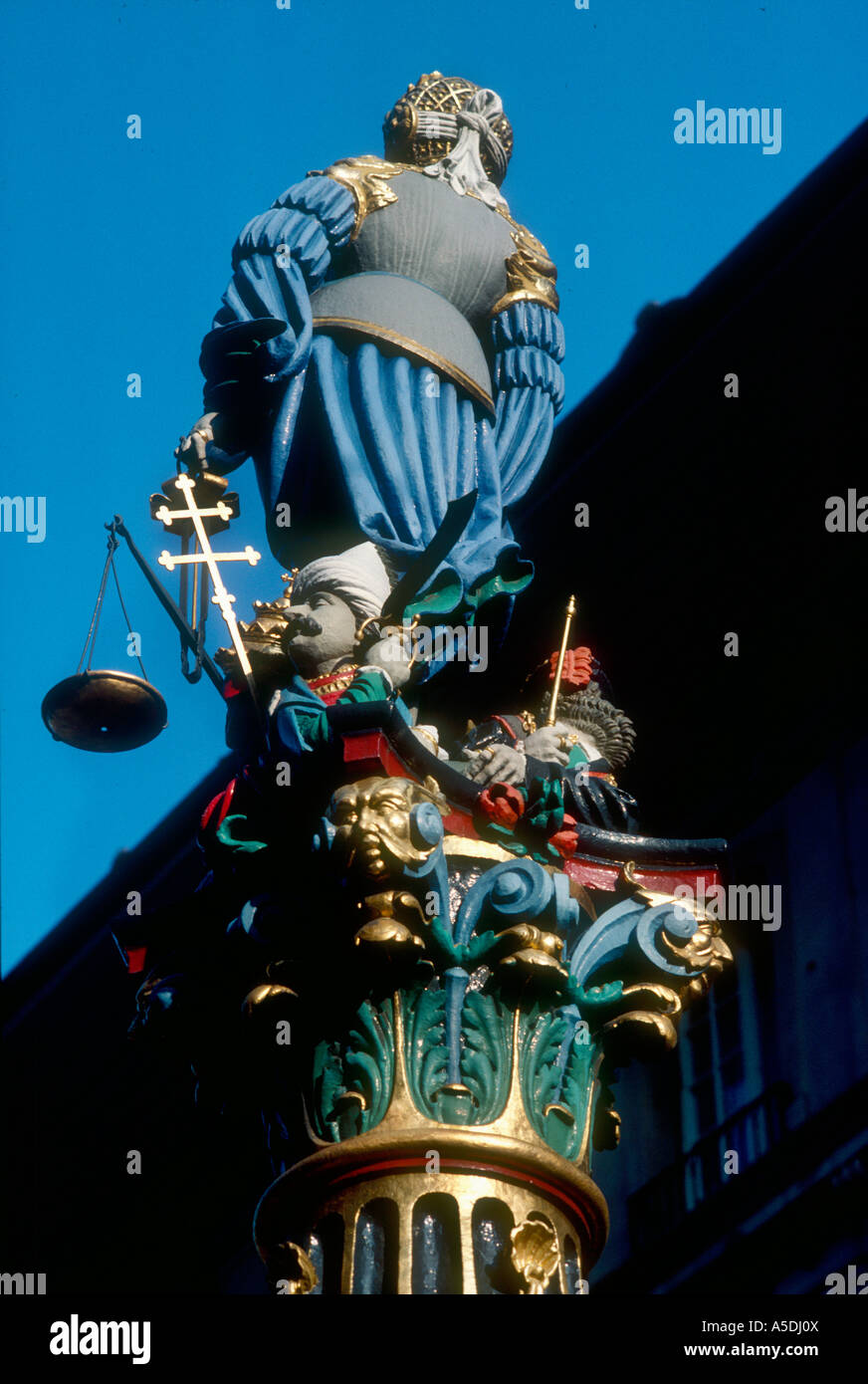 16th Century painted statue of woman and scales of justice on top of ...