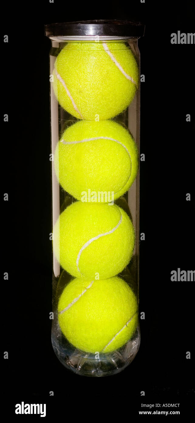 Tube of yellow tennis balls Stock Photo - Alamy
