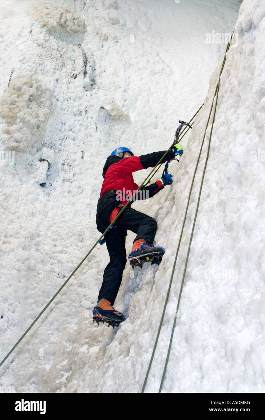 Female ascending an ice climbing wall at the Ice Factor Climbing Centre ...