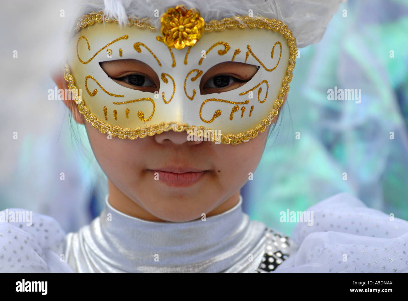 Young Chinese girl wears masquerade mask during Lunar New Year ...