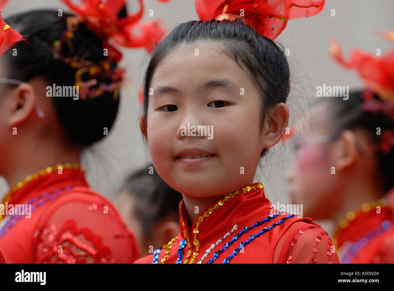 Young Chinese girl in festive outfits smiles as she takes part in the ...