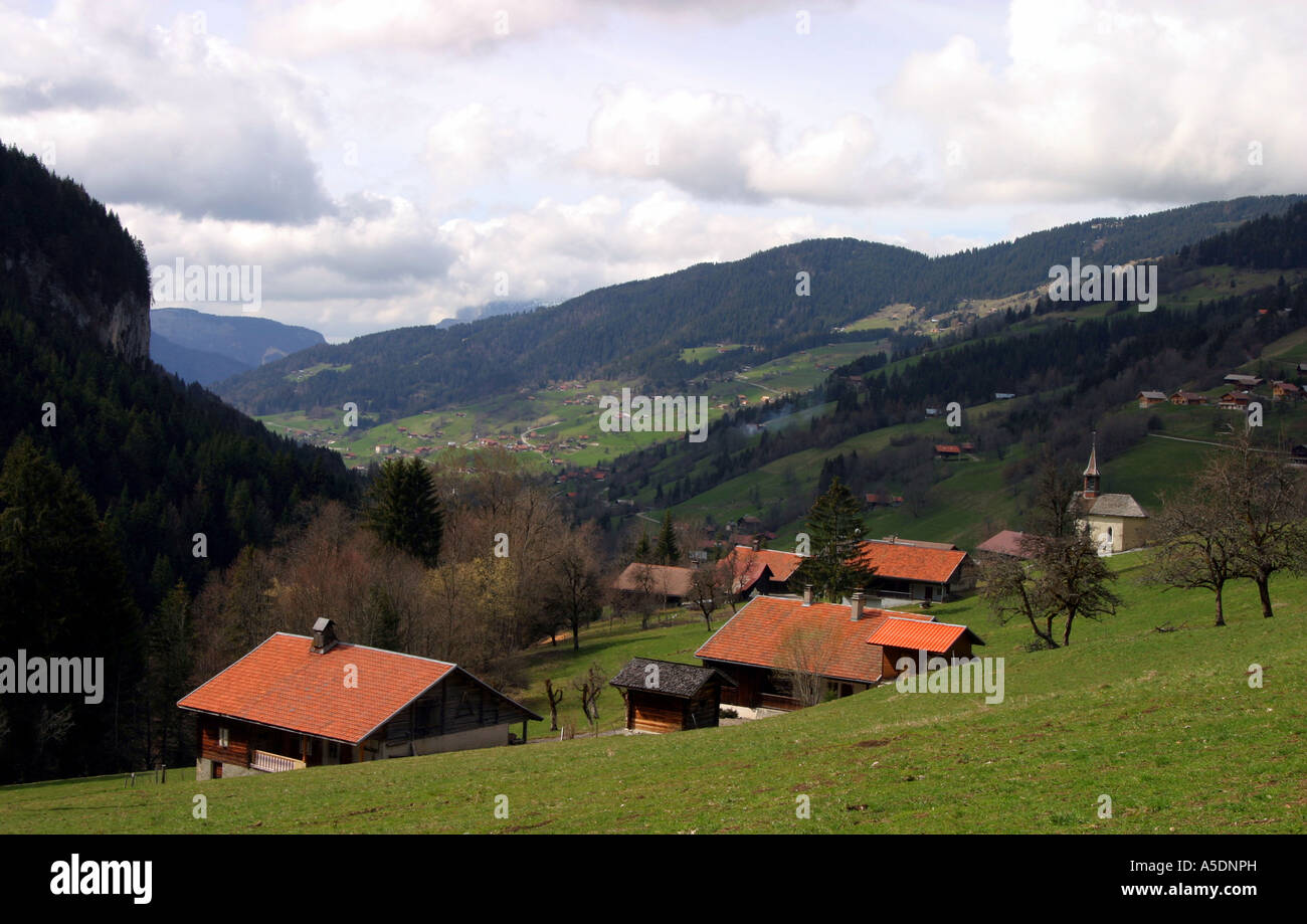 An alpine village with red rooftops nestles in a valley, French Alps ...
