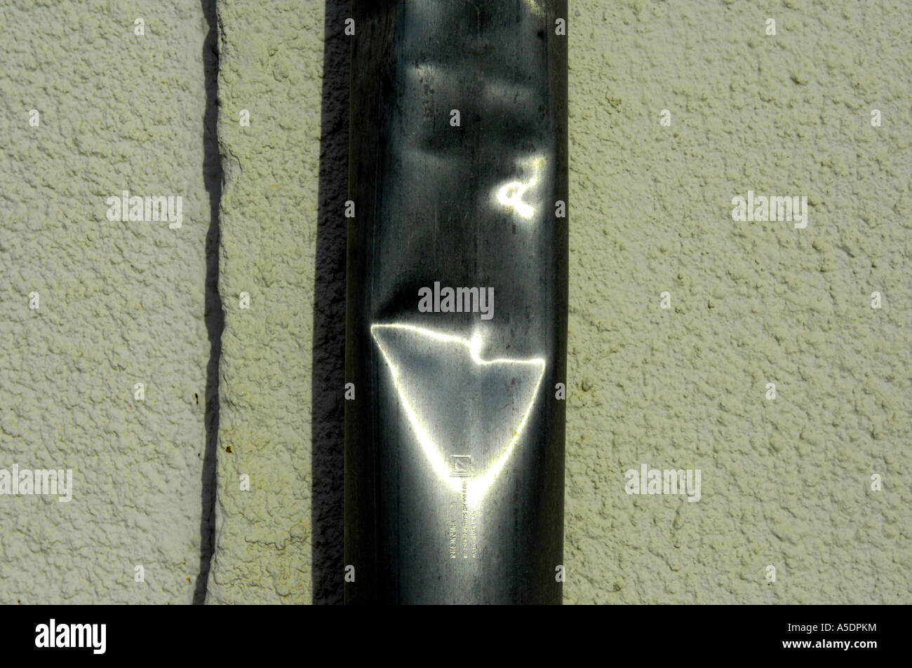 aluminium drainpipe dent dented damaged silver street urban wall detail ...